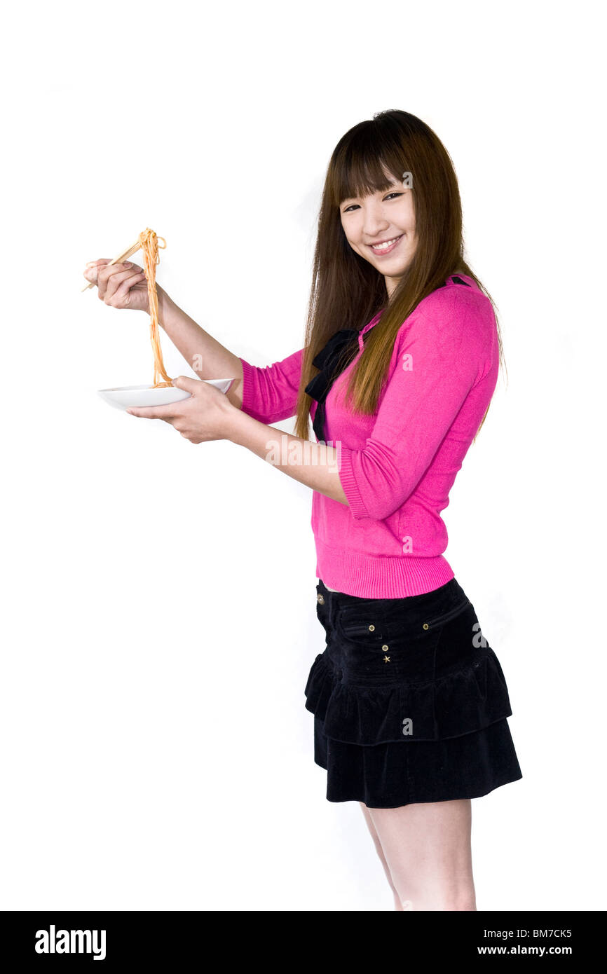 Chinese girl eating spaghetti Stock Photo - Alamy