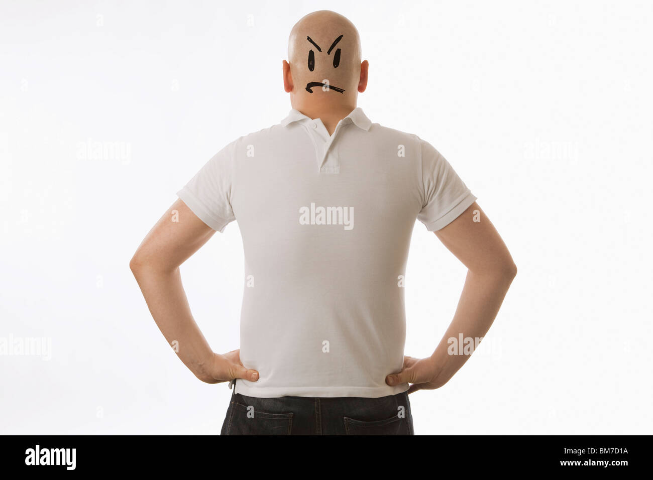A man with a face drawn on the back of his head and wearing his clothes ...