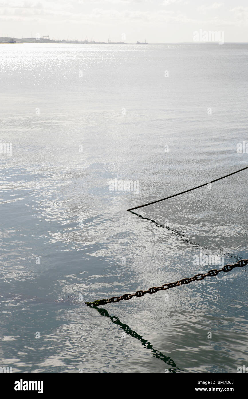 Anchor chains going into the sea Stock Photo - Alamy