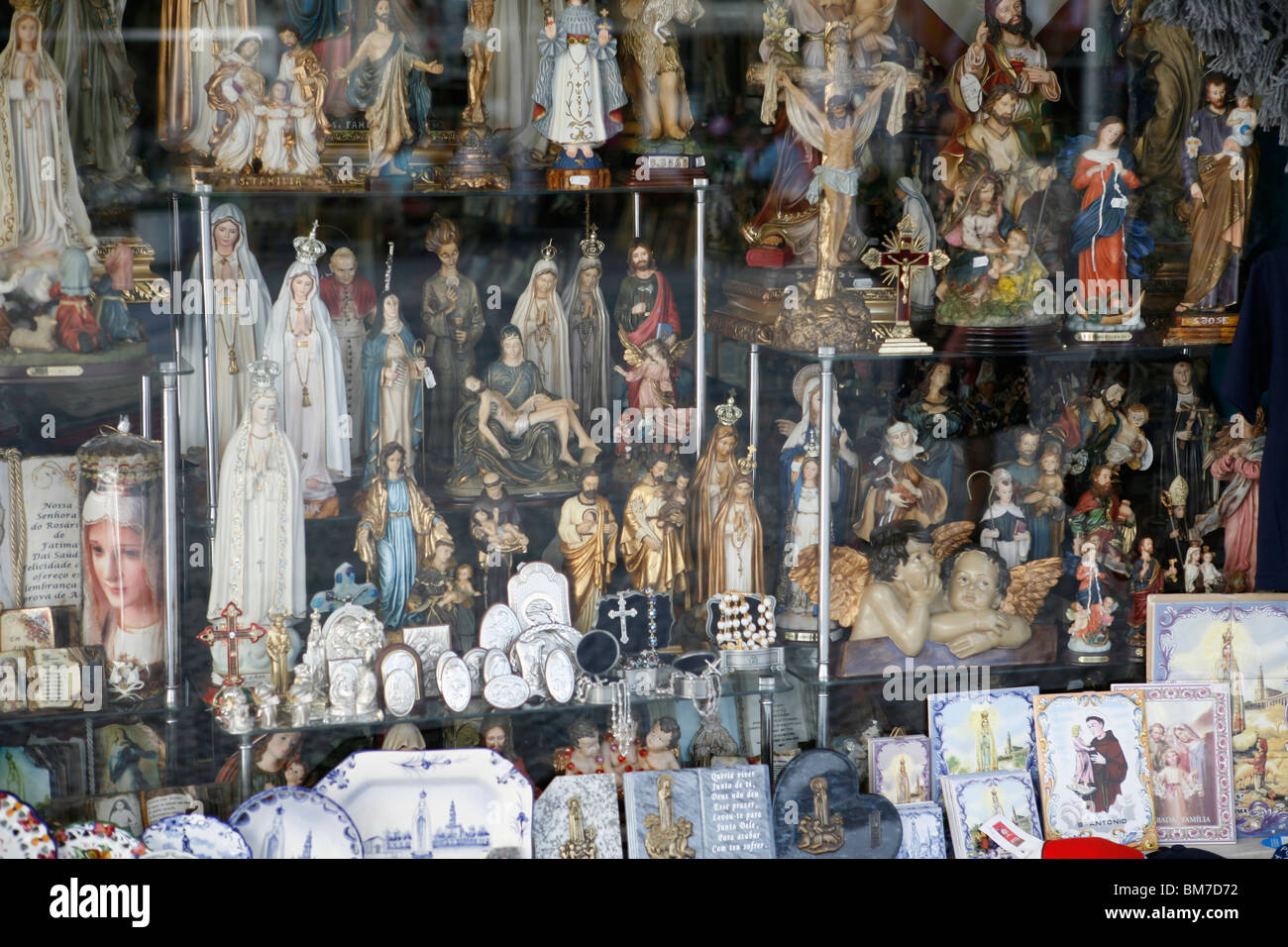 Religious icons and paraphernalia arranged in a store window Stock ...