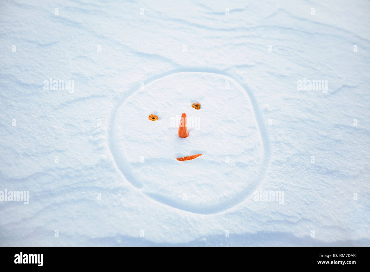 Snowman's face made in the snow Stock Photo - Alamy