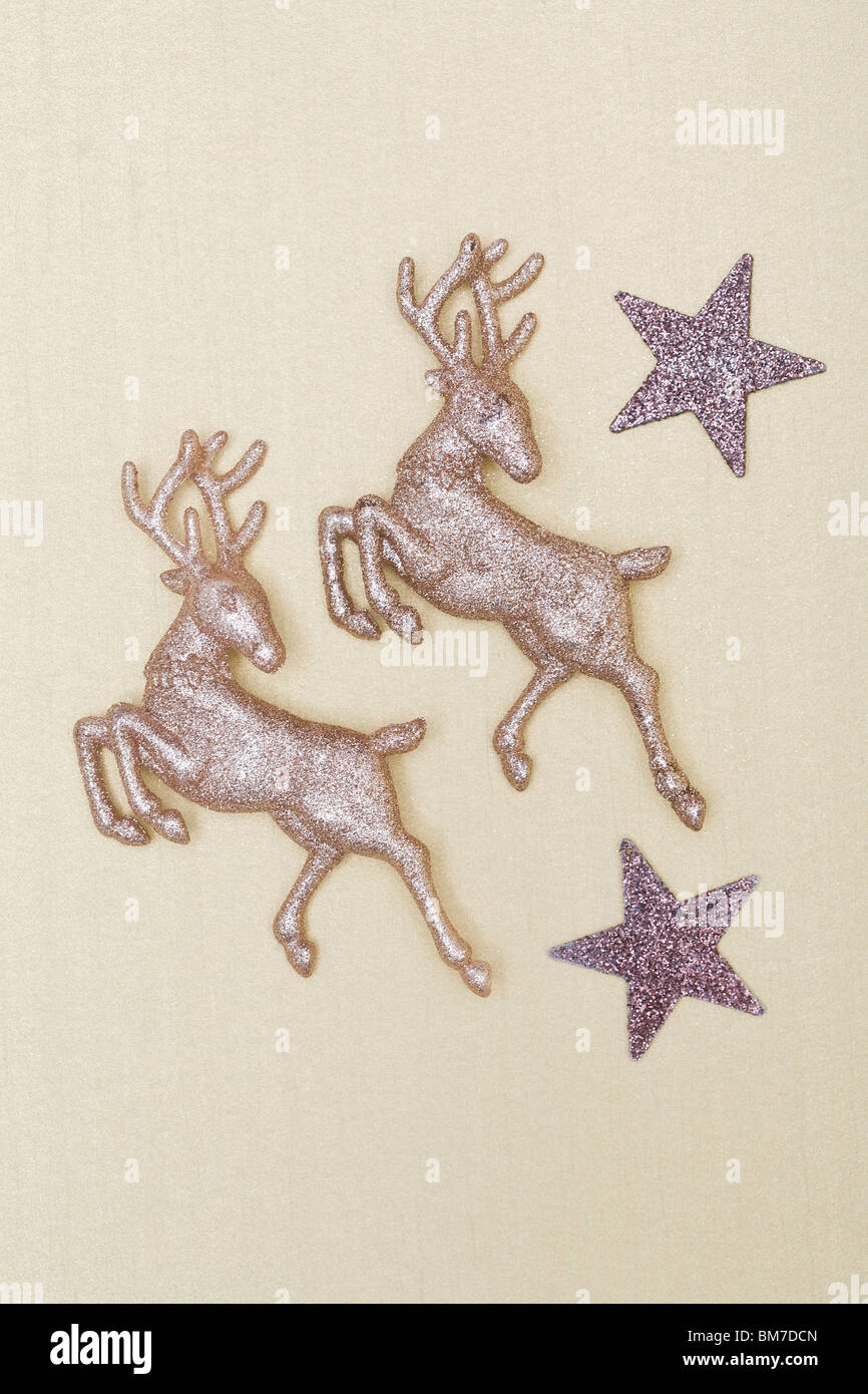 Two sparkly jumping reindeer figurines and two sparkly stars Stock ...