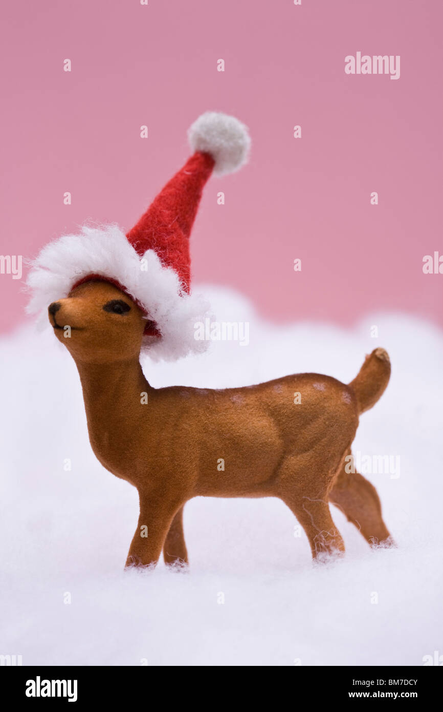 A reindeer figurine standing in fake snow Stock Photo - Alamy