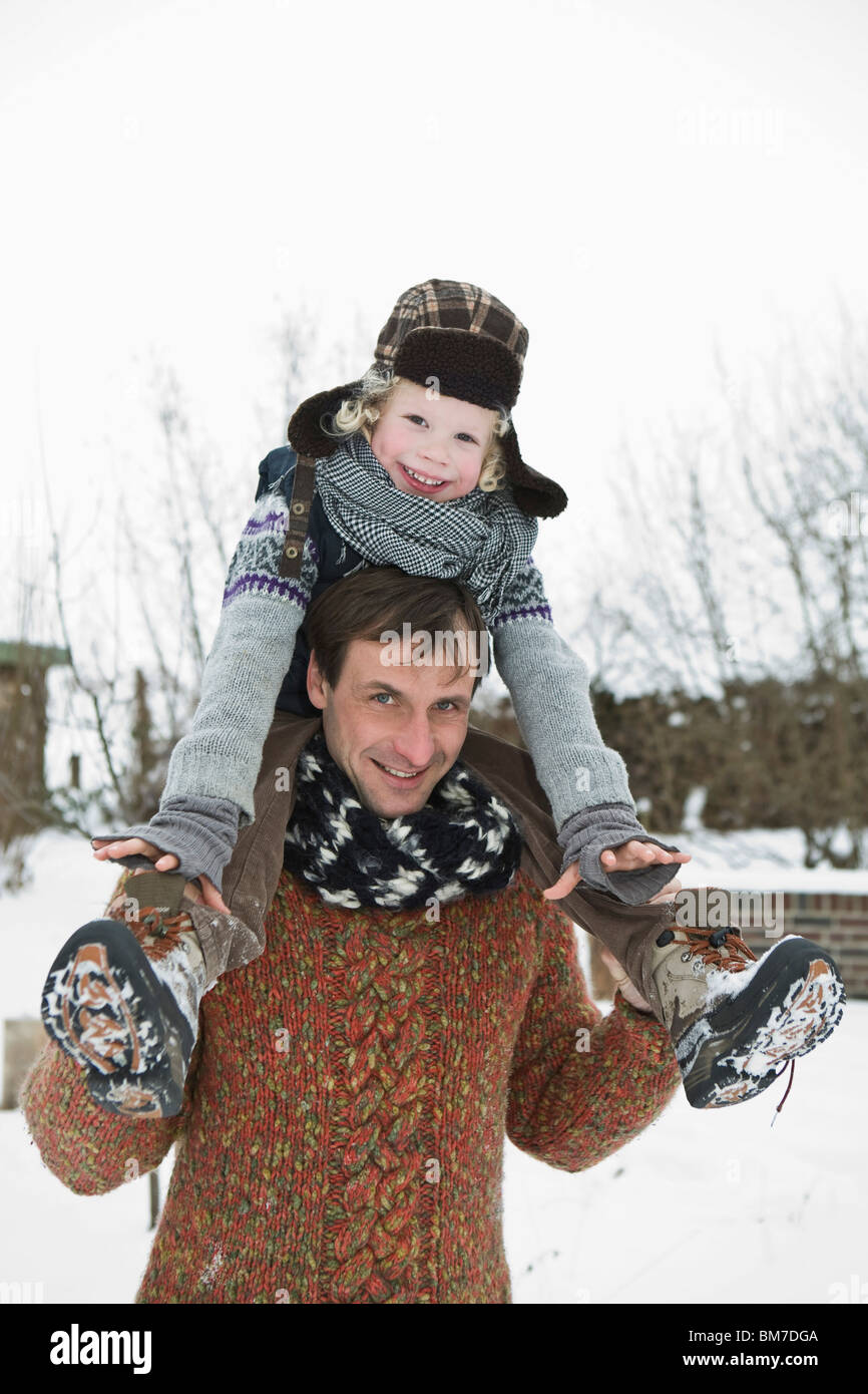 A man carrying his son on his shoulders Stock Photo - Alamy