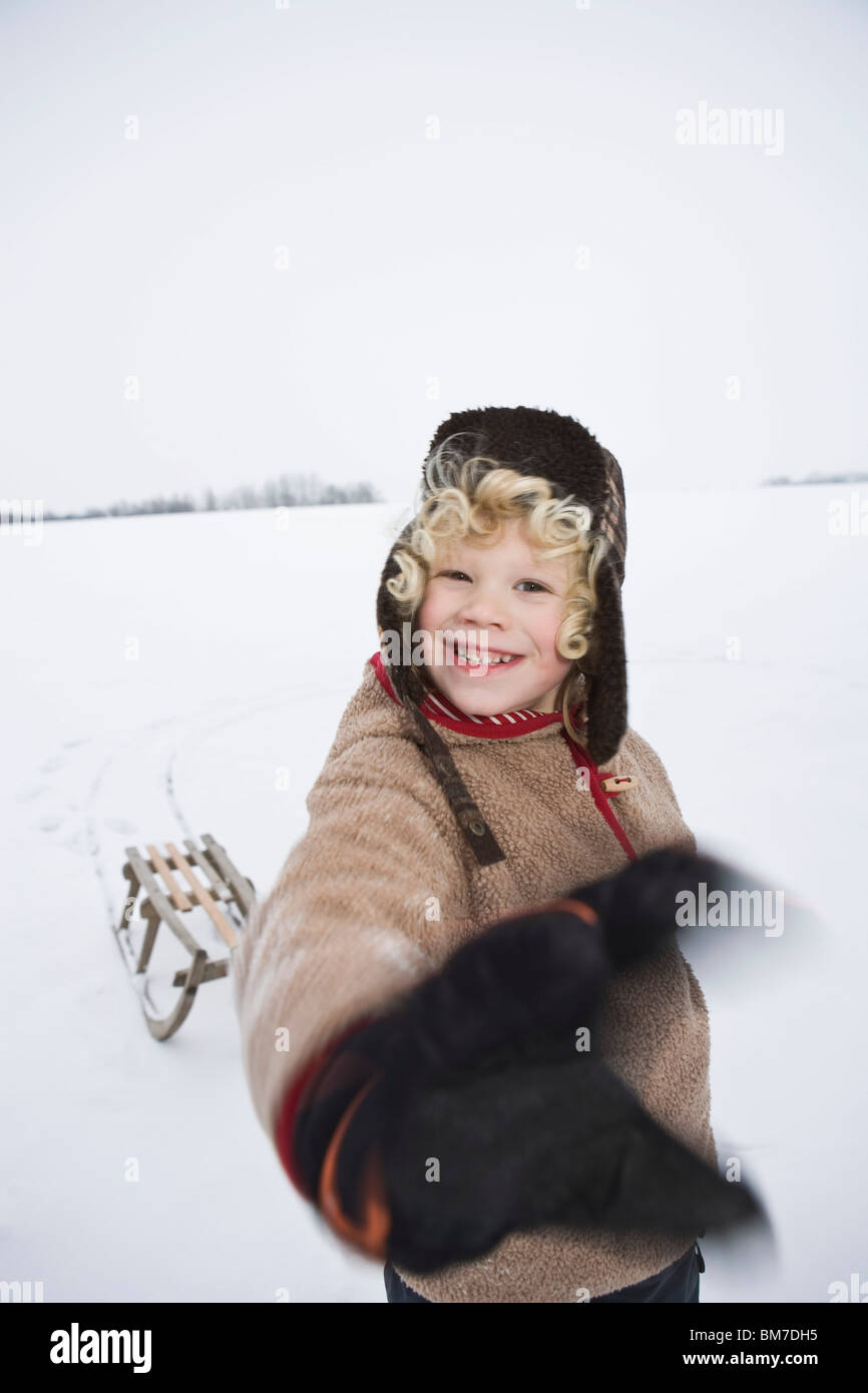A boy pulling a sled Stock Photo - Alamy