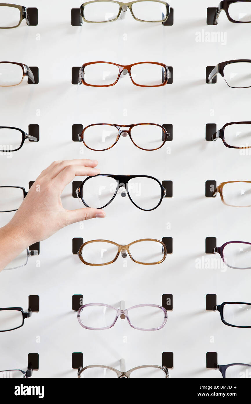 Human hand choosing pair glasses hi-res stock photography and images ...
