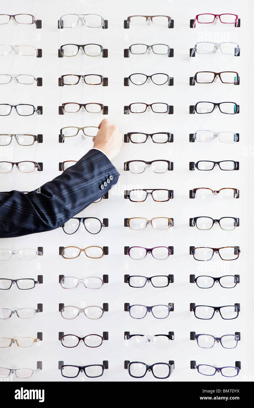 Human hand choosing pair glasses hi-res stock photography and images ...