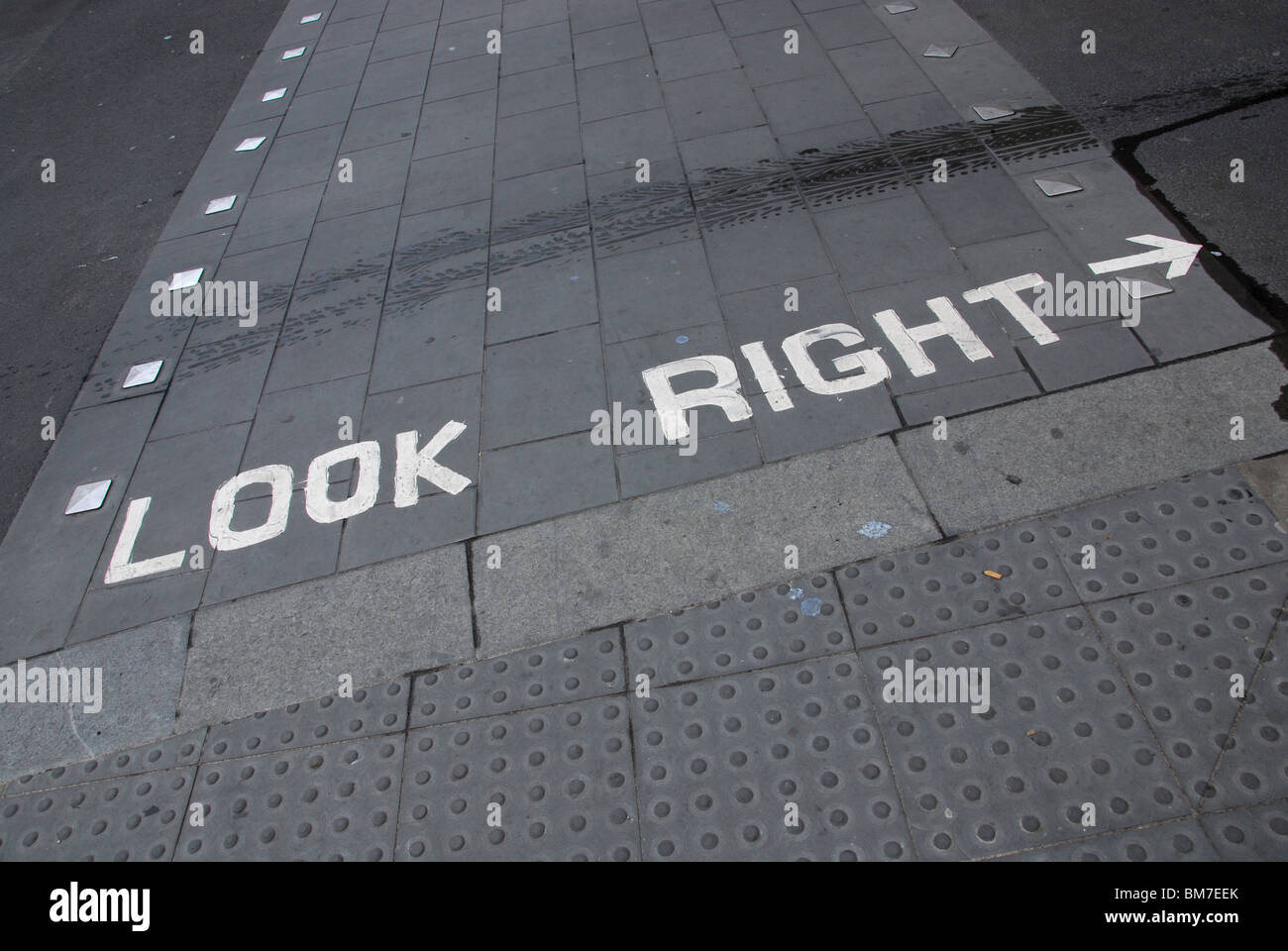 instruction and dome tiles at zebra crossing Stock Photo - Alamy