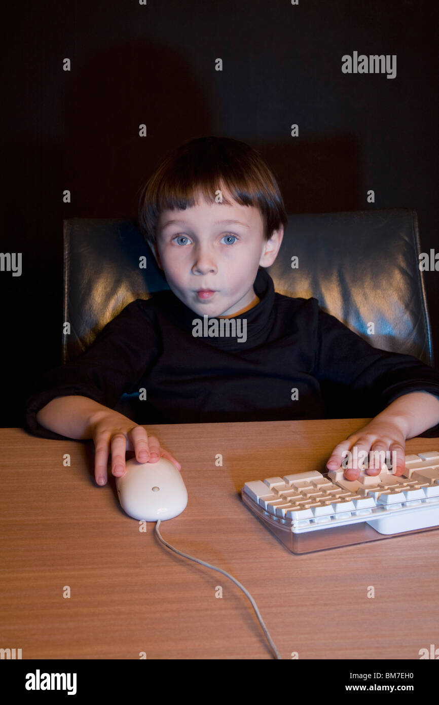 A boy using a computer mouse and keyboard Stock Photo - Alamy