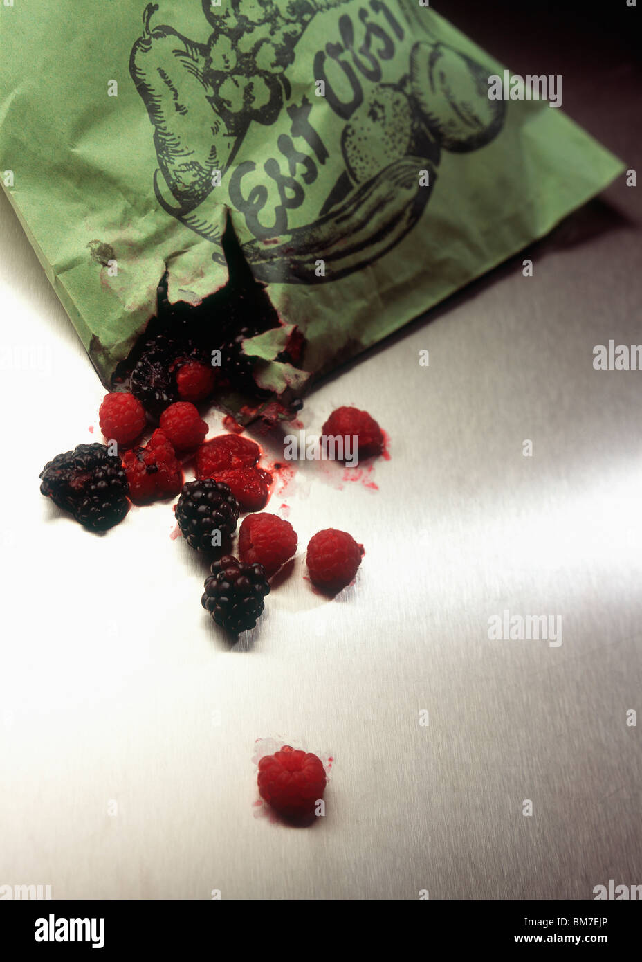 Berries spilling out of a ripped paper bag Stock Photo - Alamy