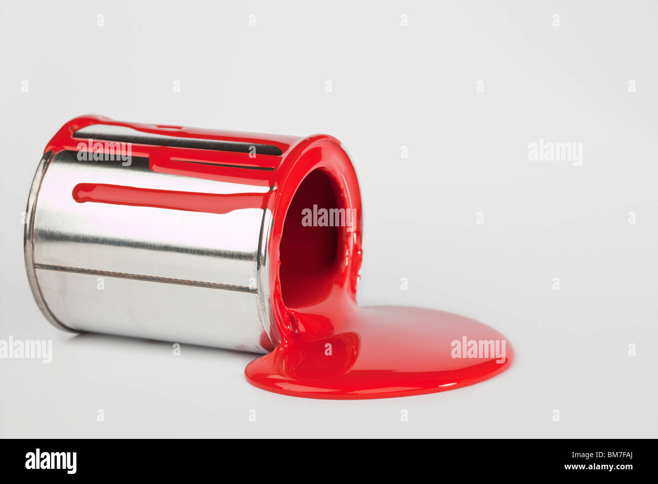 Red Paint Spilling From A Paint Can Stock Photo - Alamy