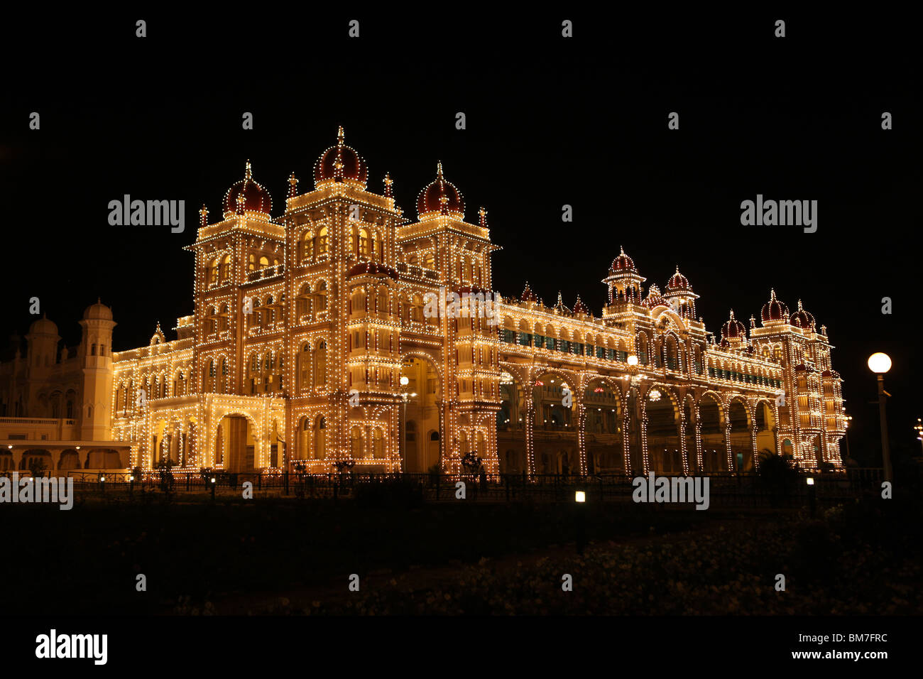 The Palace of Mysore or Mysore Palace lit up at night, located in ...