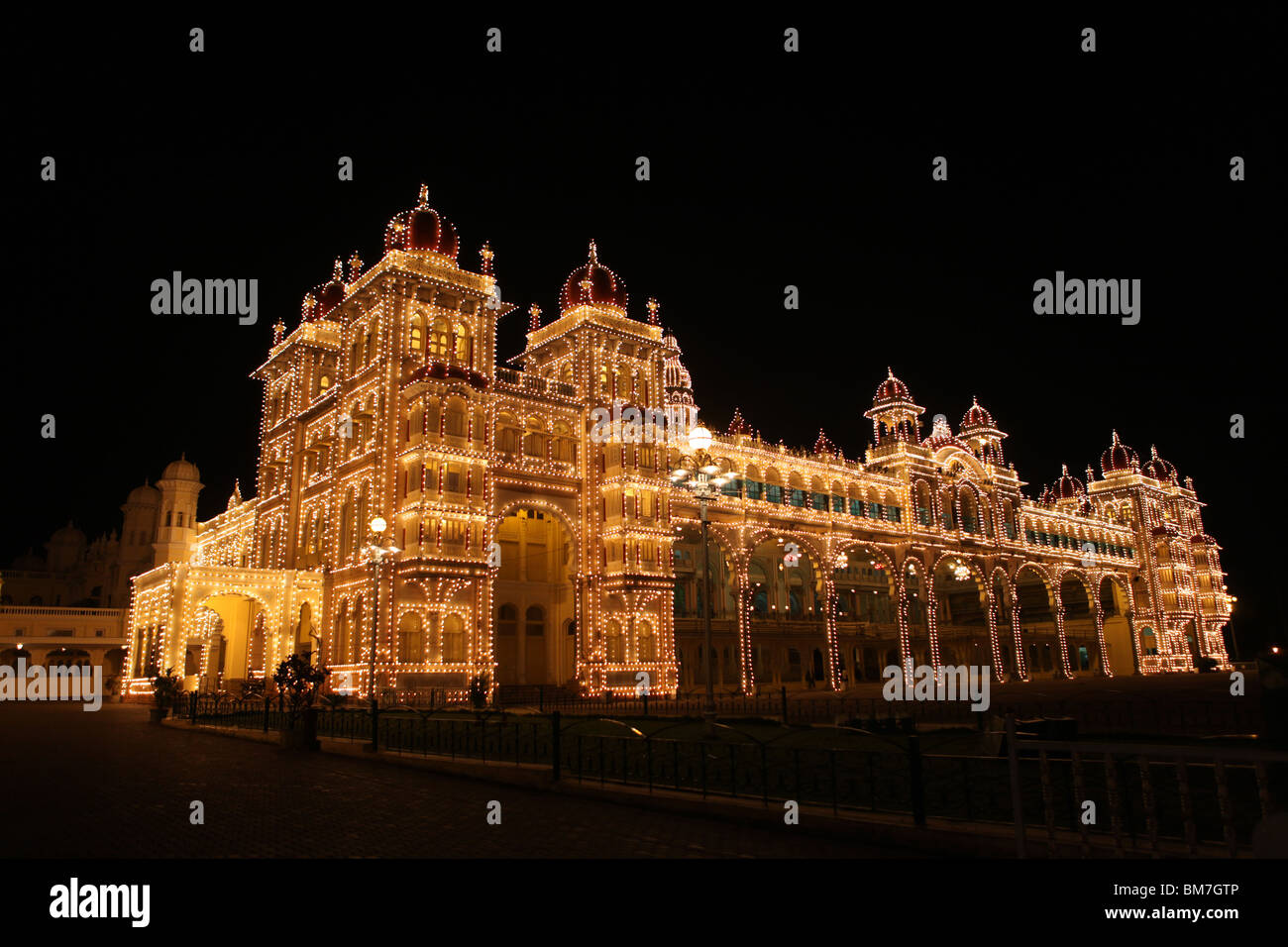 The Palace of Mysore or Mysore Palace lit up at night, located in ...
