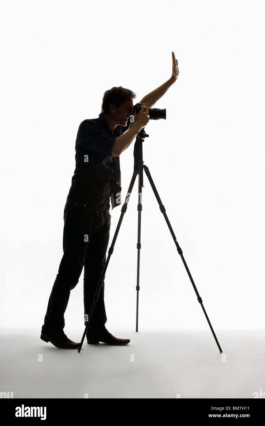 Man looking through camera on tripod hi-res stock photography and ...
