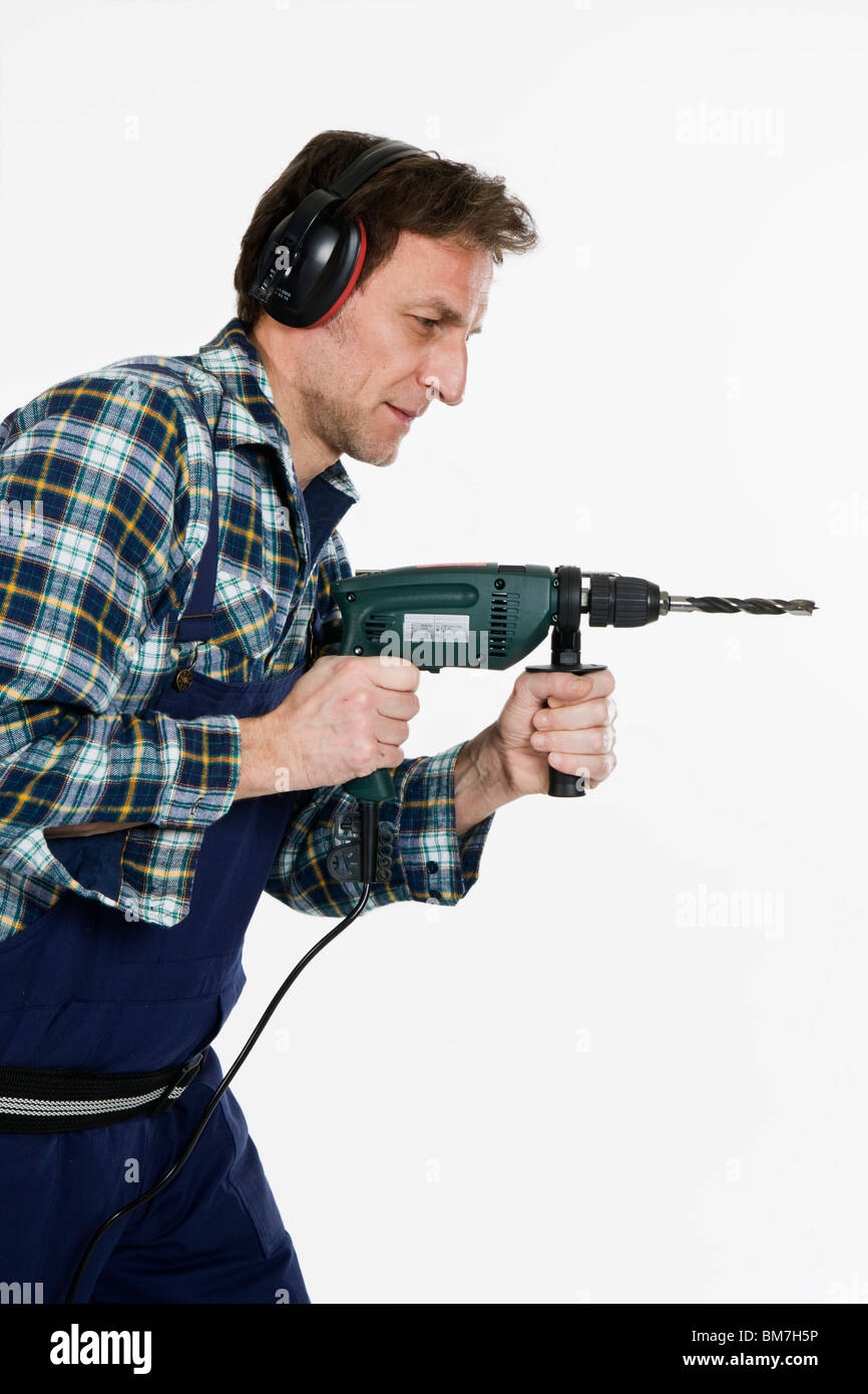 A construction worker using a drill Stock Photo - Alamy