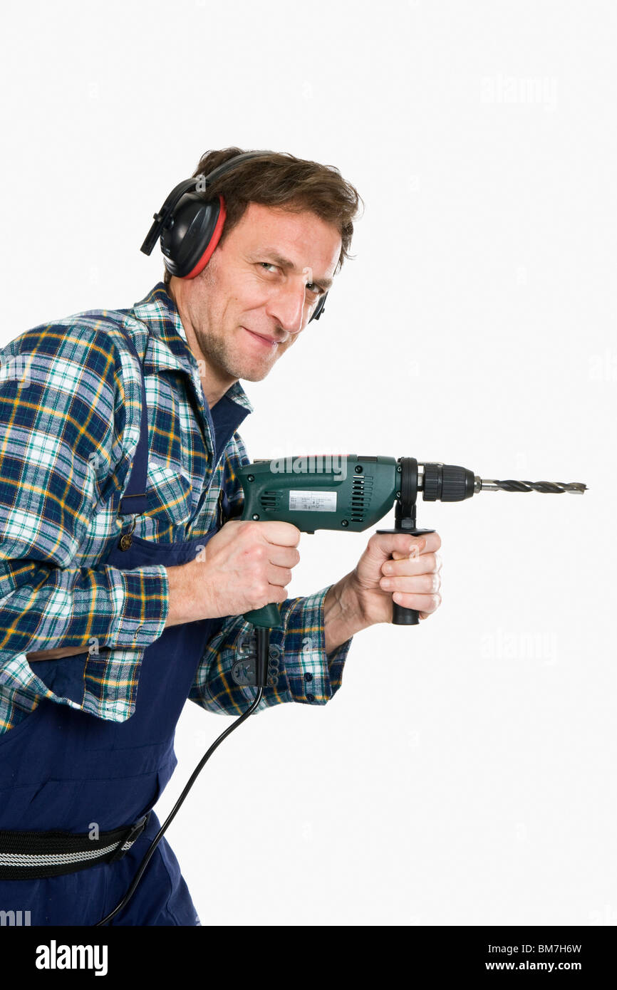 A construction worker using a drill Stock Photo - Alamy