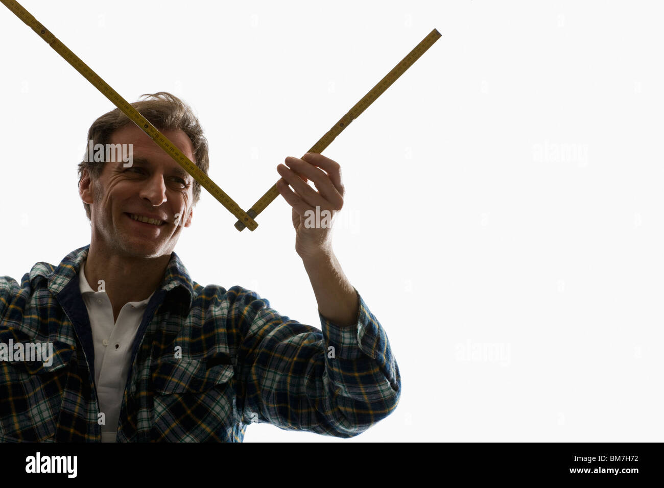 A carpenter using a folding ruler Stock Photo - Alamy