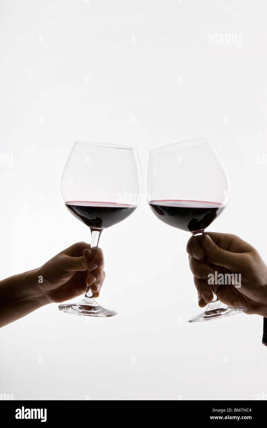 Two people toasting wineglasses, focus on hands Stock Photo - Alamy