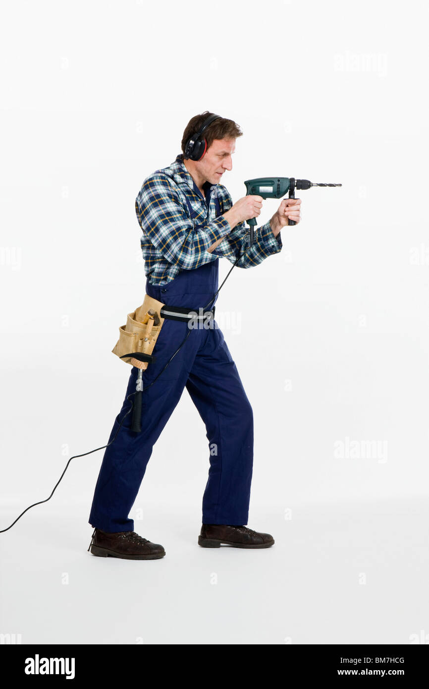 A construction worker using a drill Stock Photo - Alamy