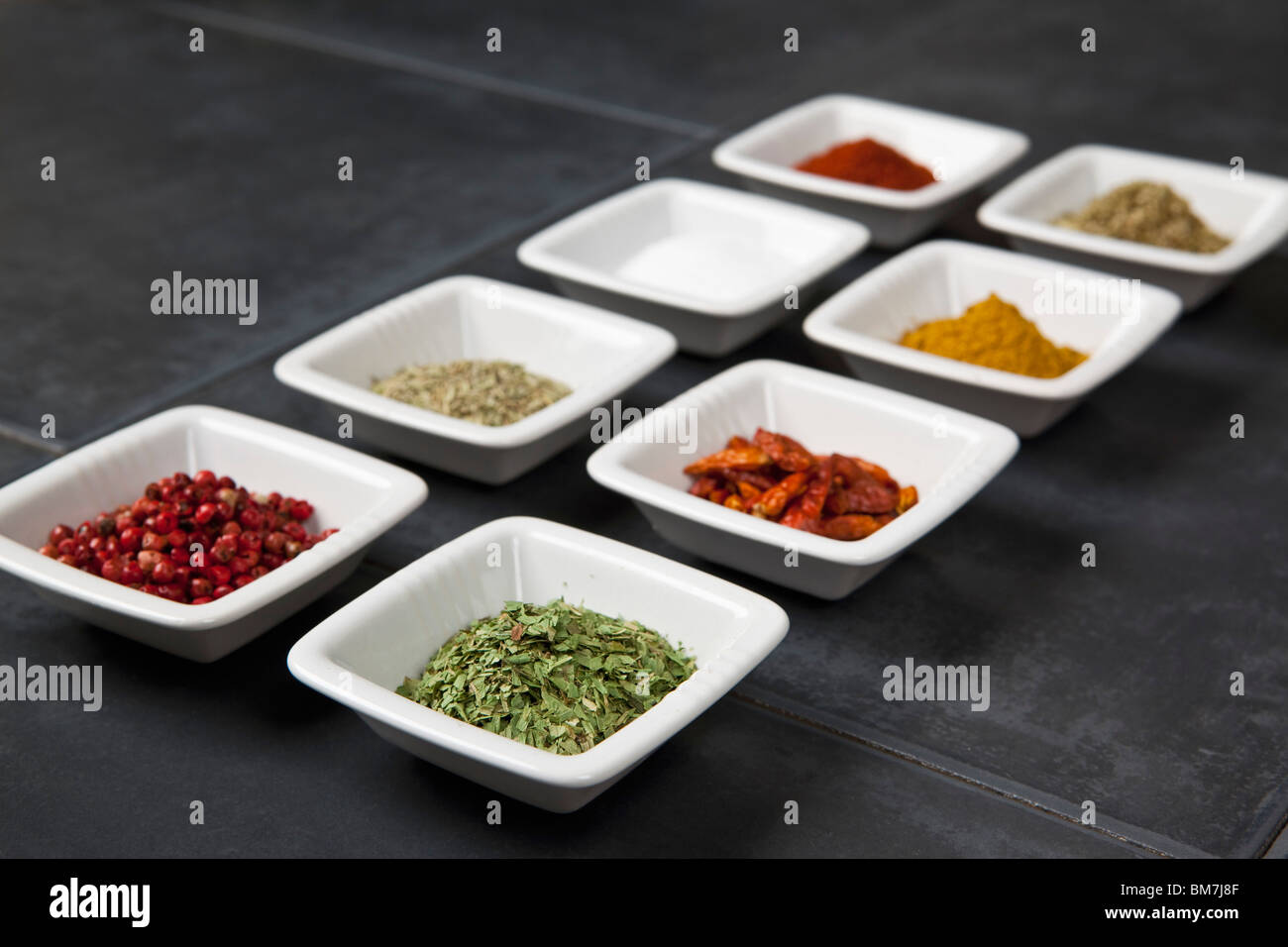 Various herbs and spices in small bowls Stock Photo - Alamy