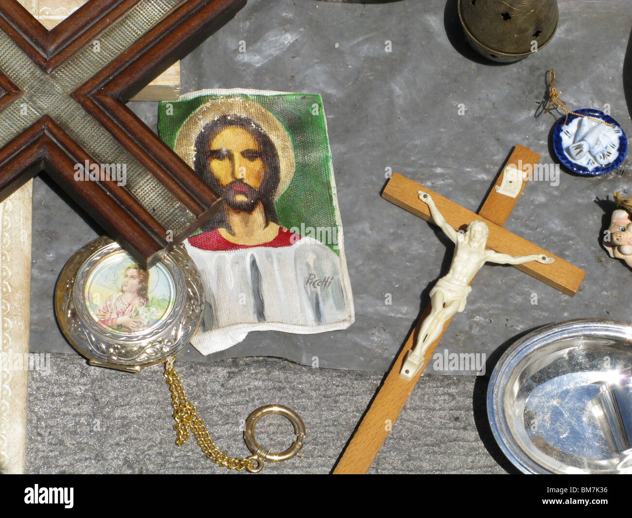 religious objects for sale on market stall in sun Stock Photo - Alamy
