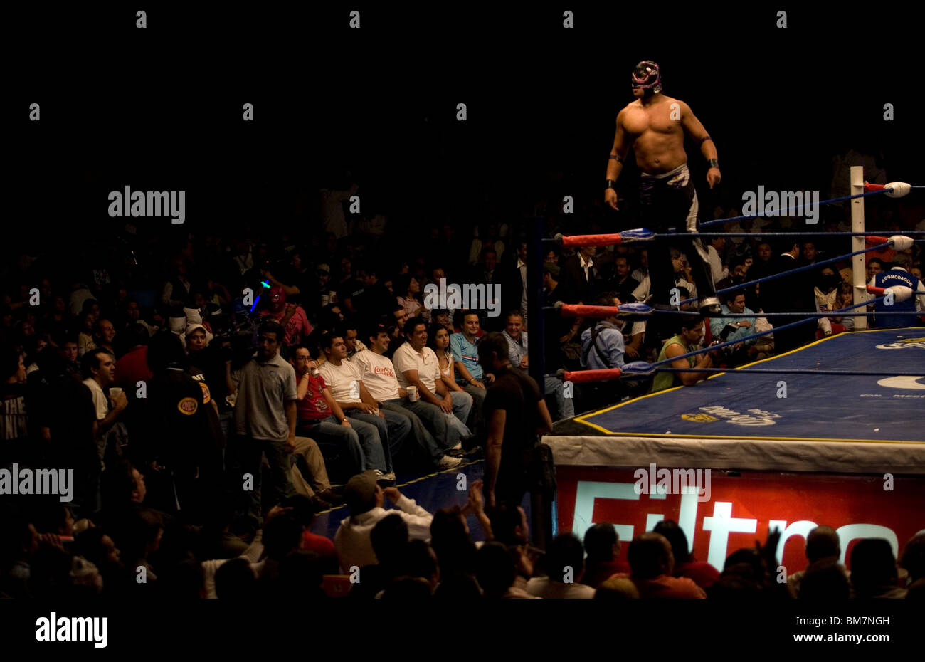 A wrestler gestures to the crowd during a Lucha Libre event in Arena ...