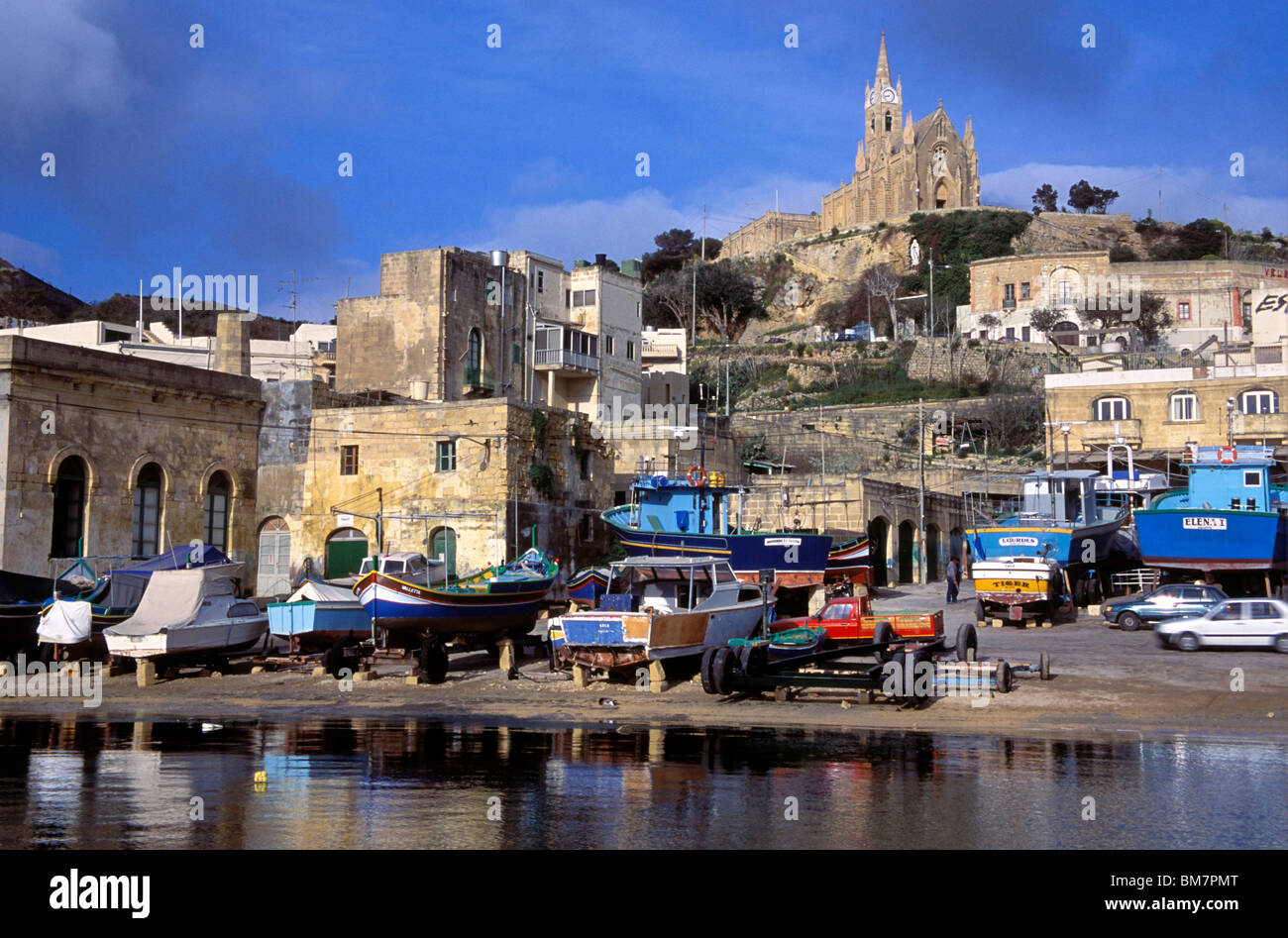 Malta, vernacular wooden boats, called Luzzu, and old buildings and ...