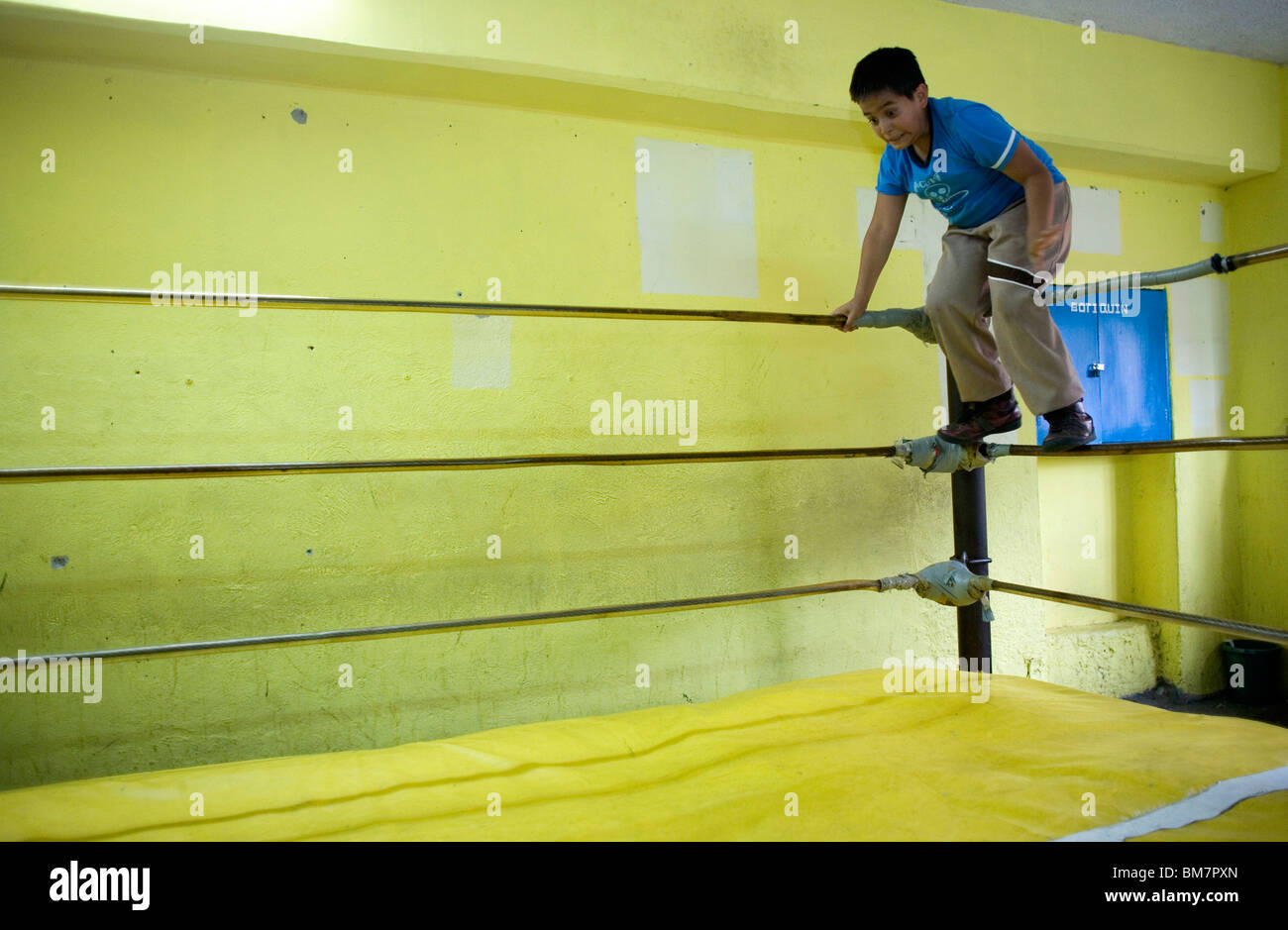 A young student prepares to jump from the rings at a mexican wrestling ...