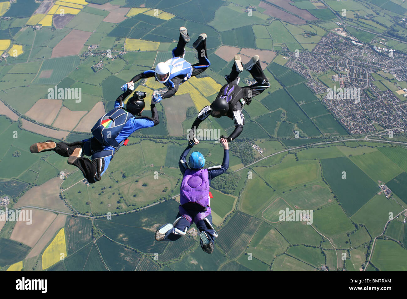 Four skydivers in free fall doing formations Stock Photo - Alamy