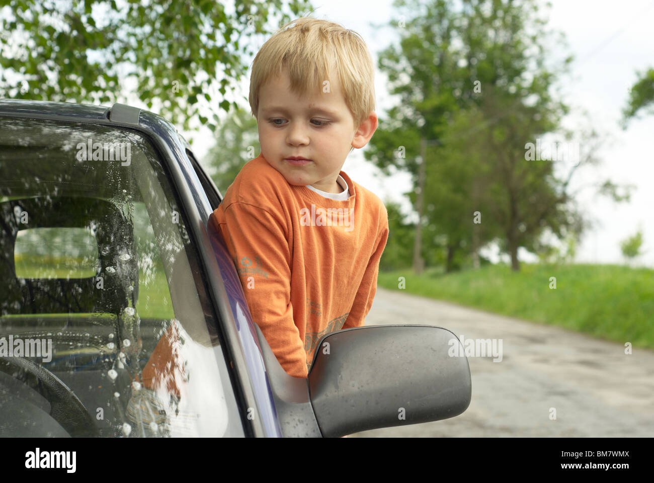 Child blond boy driving - playing with real car Stock Photo - Alamy