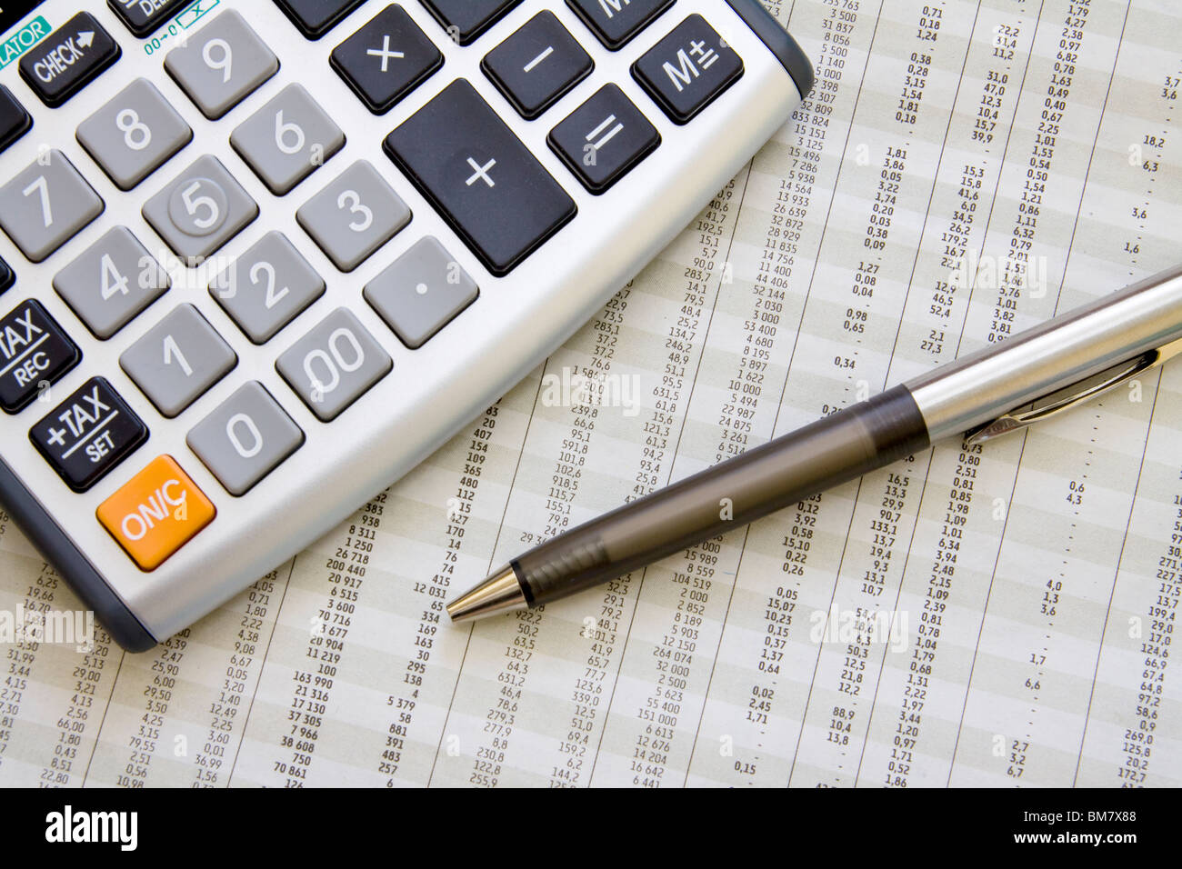 A calculator, pen, and financial statement Stock Photo - Alamy