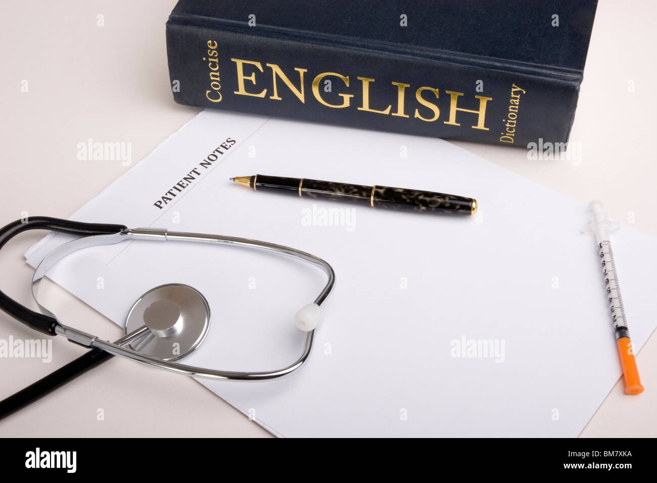 Patient notes, stethoscope and an English dictionary Stock Photo - Alamy