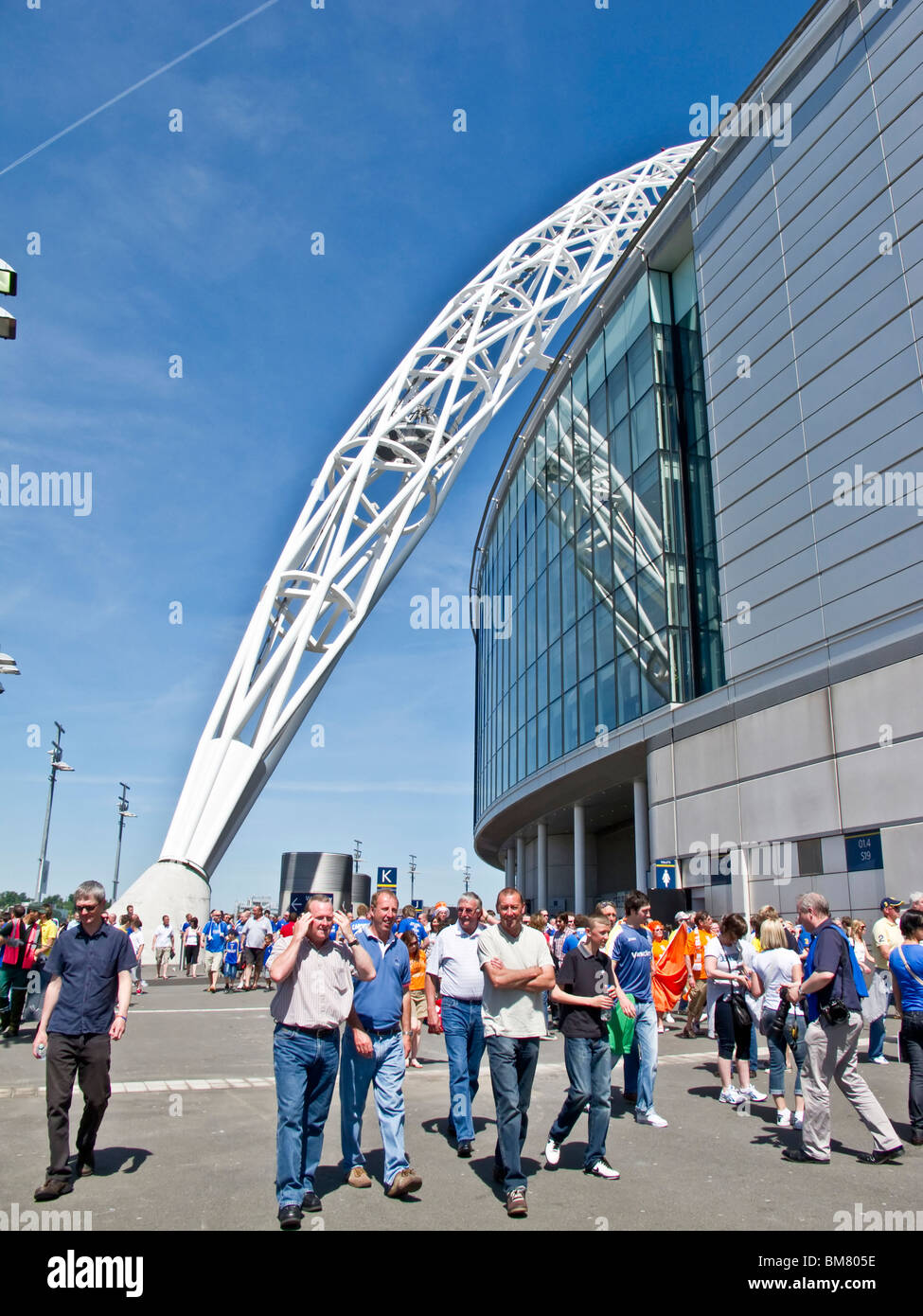The base of the steel arch over Wembley Stadium with fans attending the ...