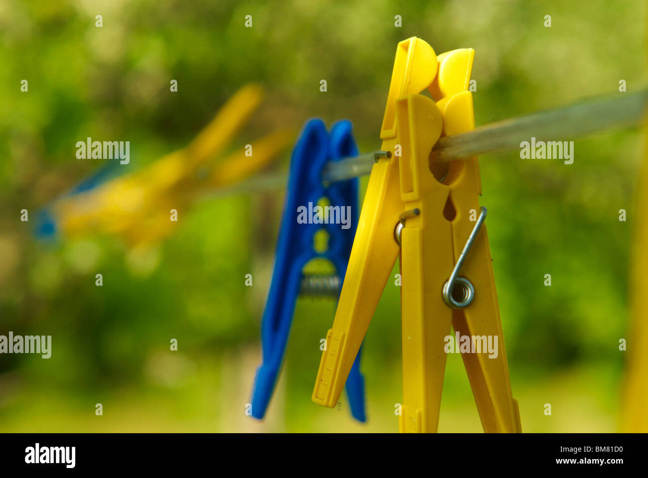 Multicolored pegs pin on a washing line Stock Photo - Alamy