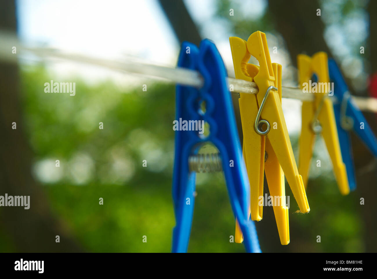 Multicolored pegs pin on a washing line Stock Photo - Alamy