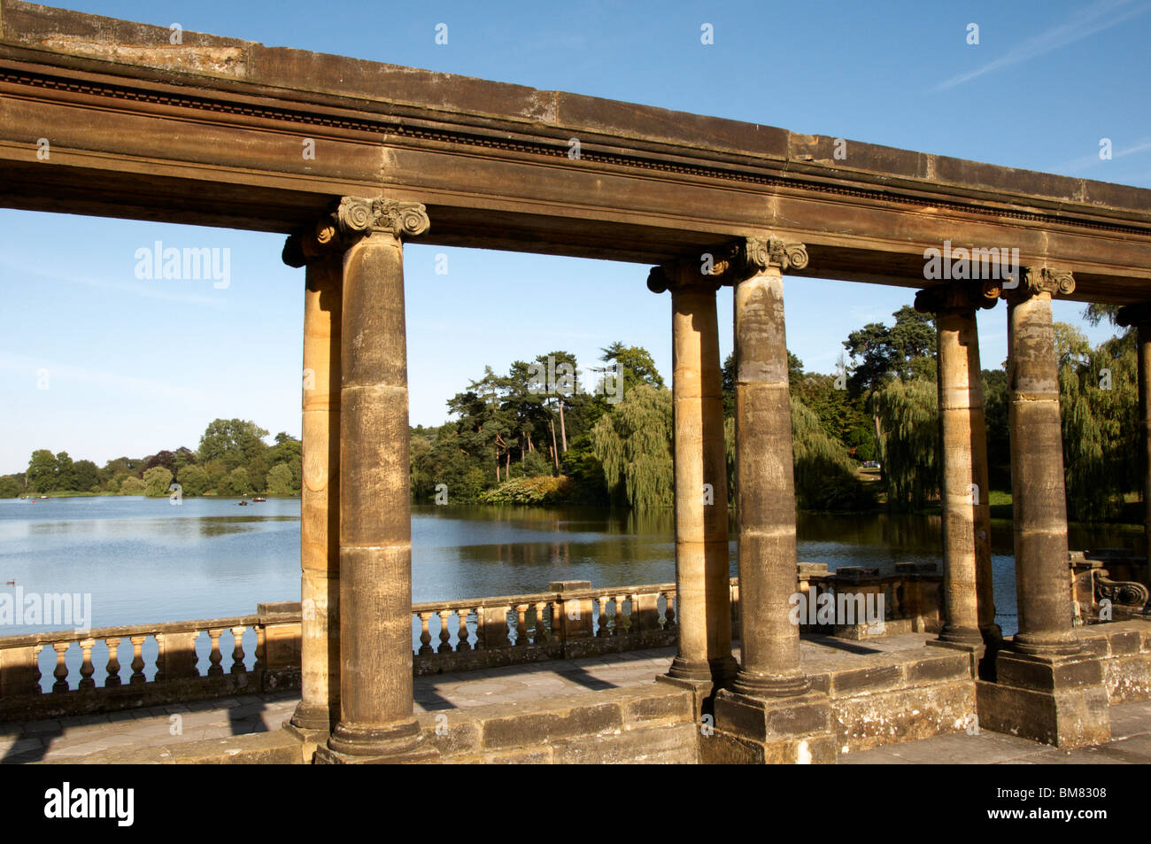 A row of column's with a lake in the background Stock Photo - Alamy