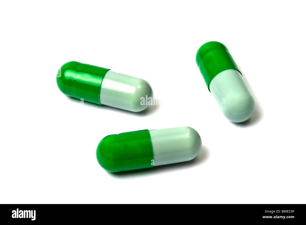 Green capsules isolated on white background Stock Photo - Alamy