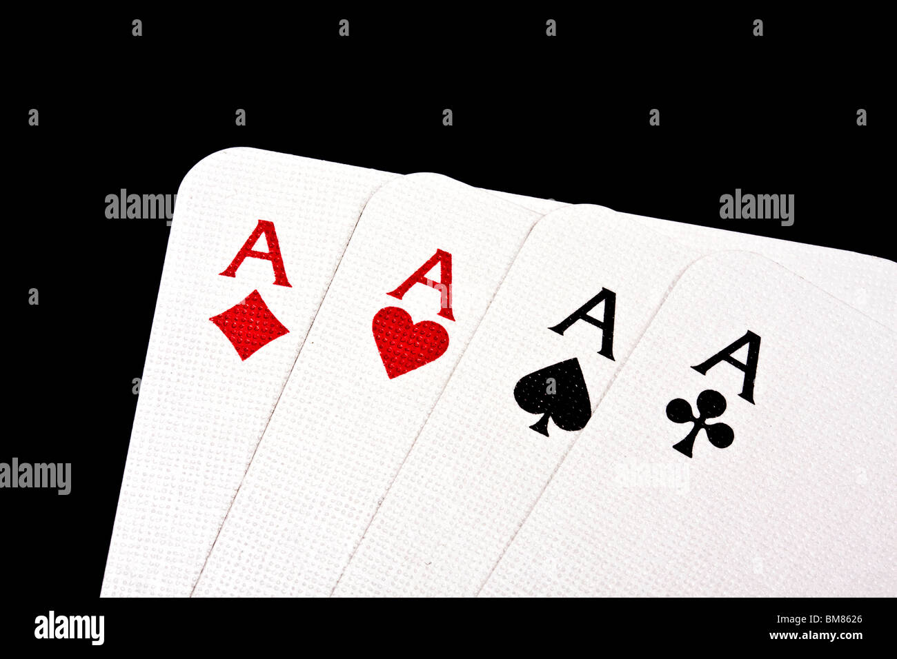 Four aces isolated on black background Stock Photo - Alamy