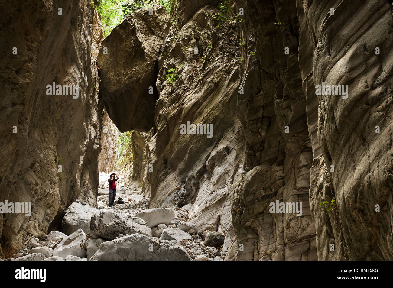 A walker at the narrowest point of the Ridomo Gorge. In the Taygetos ...