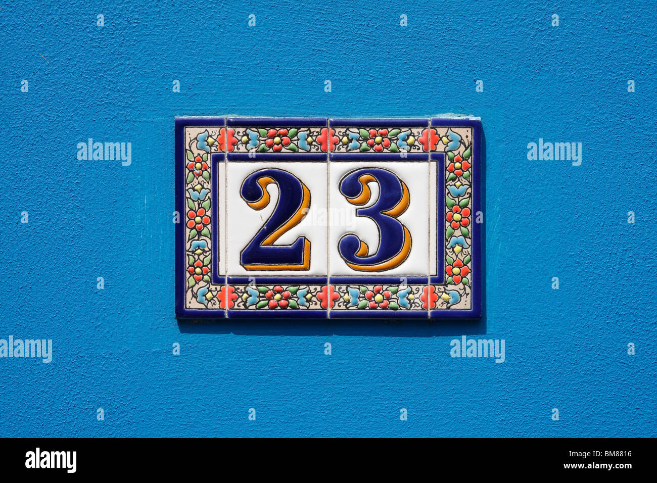 Porcelain house number tiles on cyan wall Stock Photo - Alamy