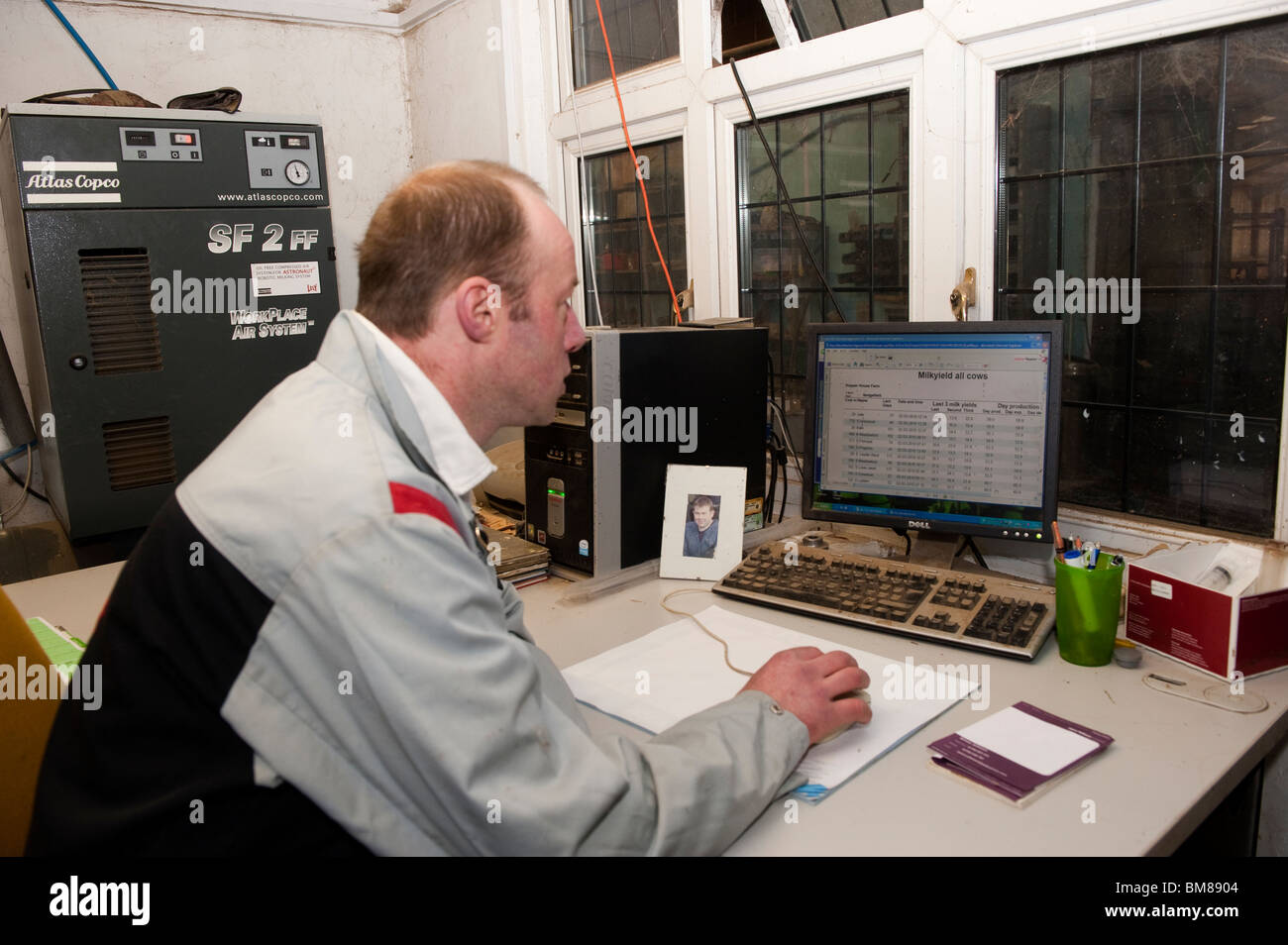 Farmer working on a computer in his office Stock Photo - Alamy