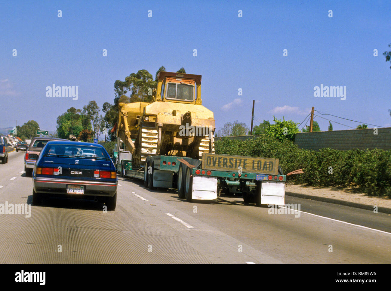 Oversize load highway freeway earthmover tractor bulldozer on truck ...