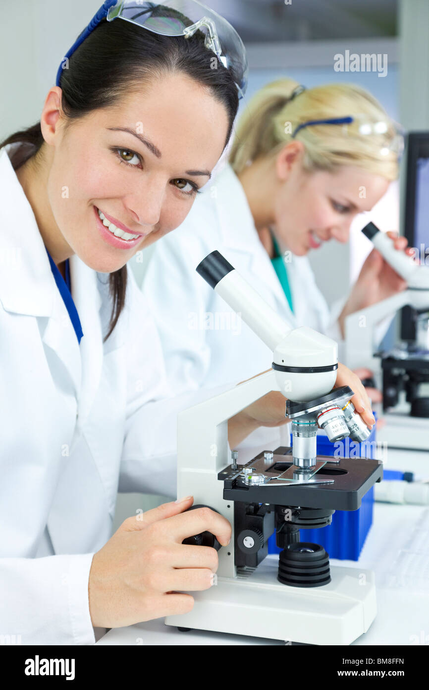 A female medical or scientific researcher or doctor using her ...