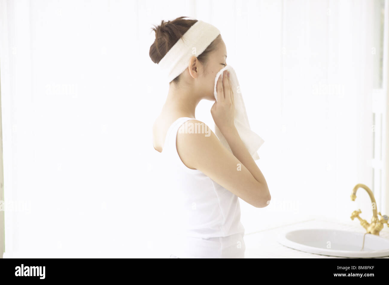 Young woman drying face Stock Photo - Alamy