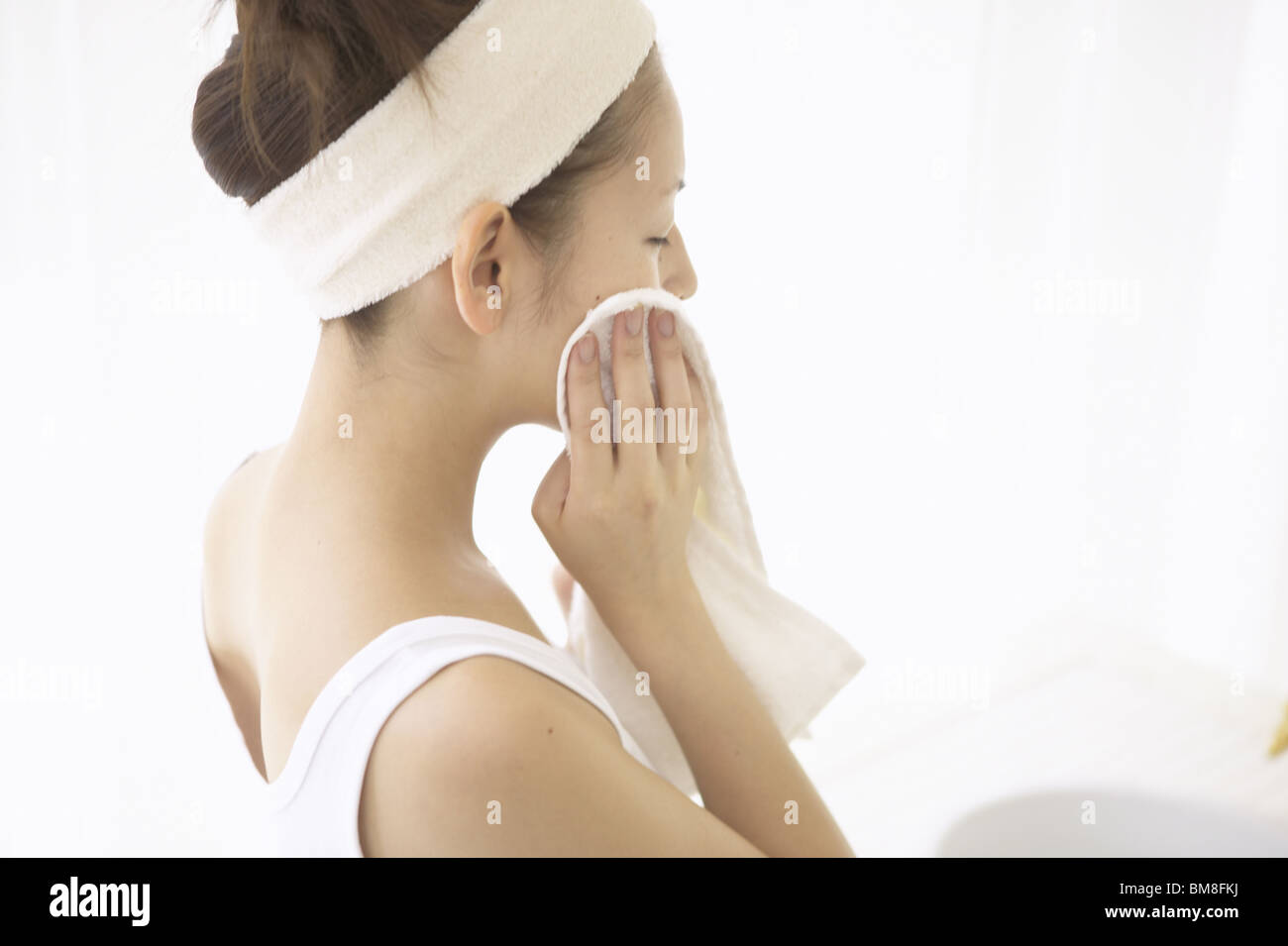 Young woman drying face Stock Photo - Alamy