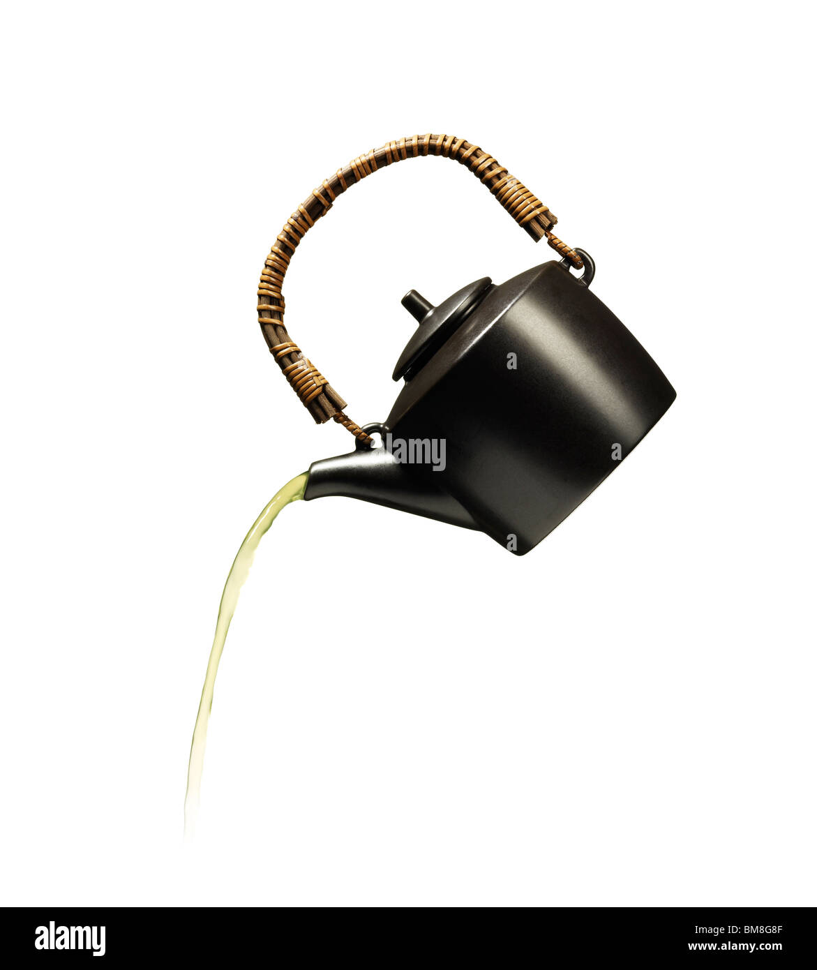 Green tea pouring from teapot Stock Photo - Alamy