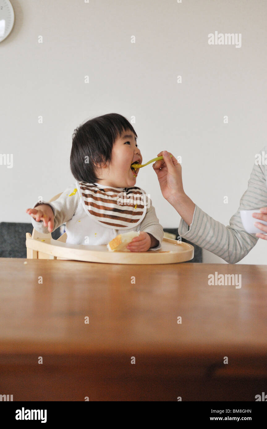 Mother feeding baby boy Stock Photo - Alamy