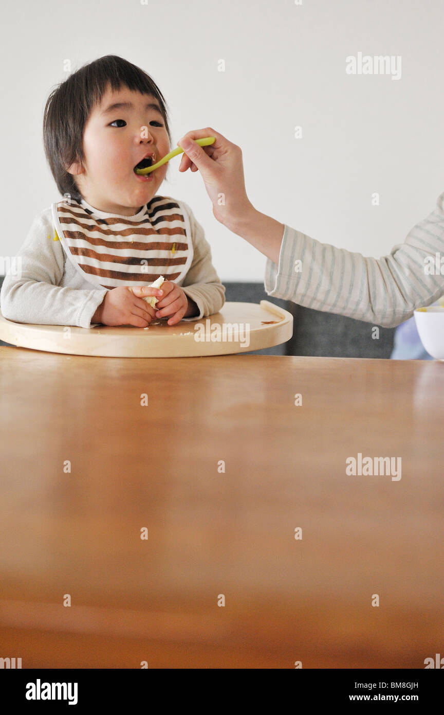Mother feeding baby boy Stock Photo - Alamy