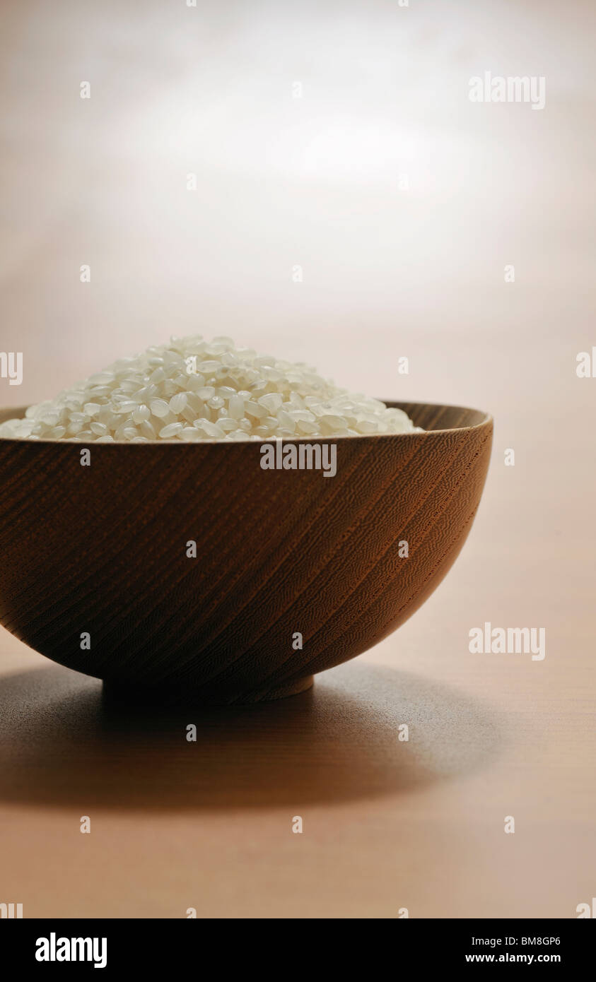 Bowl of raw rice Stock Photo - Alamy