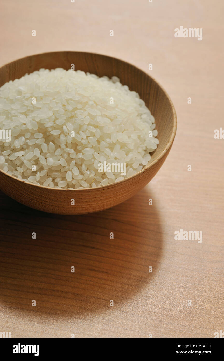 Bowl of raw rice Stock Photo - Alamy